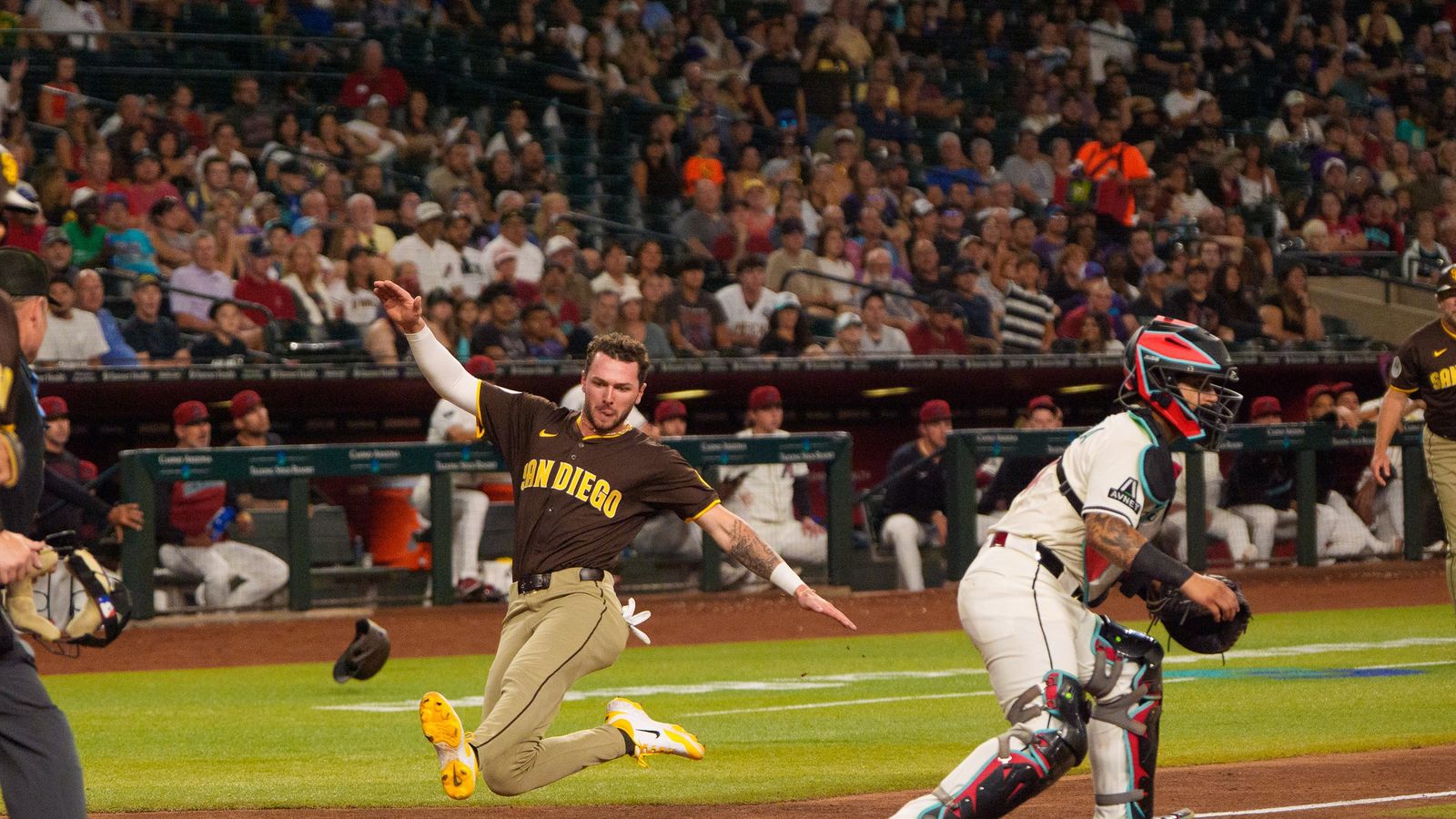 Padres score five runs in extras to even series against Diamondbacks